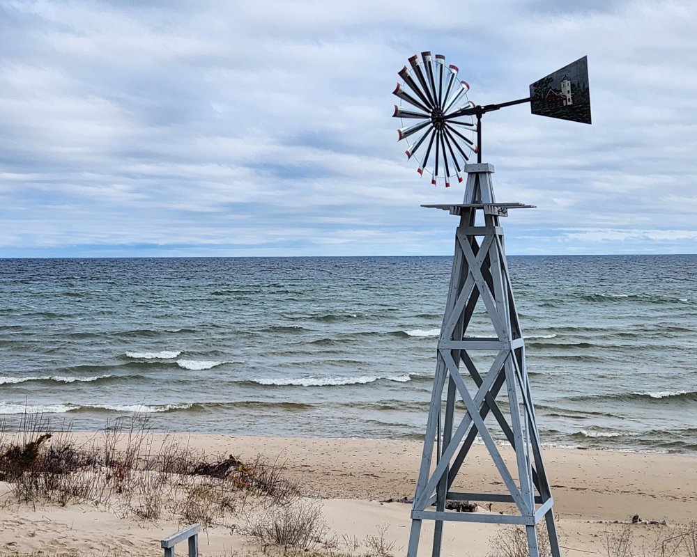 Traditional Wooden Windmill on Sandy Beach Overlooking Blue Sea | Deep ...